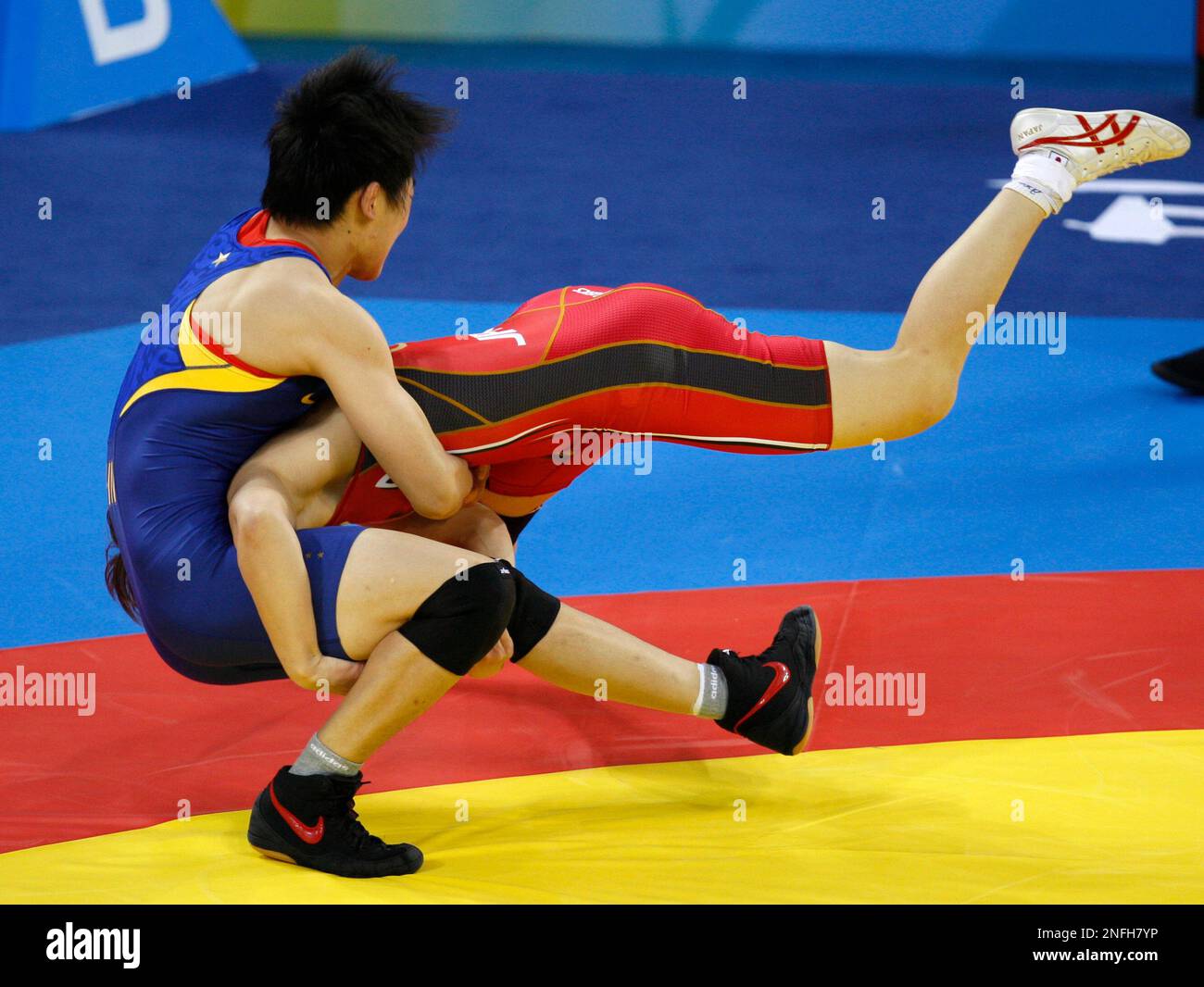 Saori Yoshida of Japan, in red, wrestles against Xu Li of China during ...