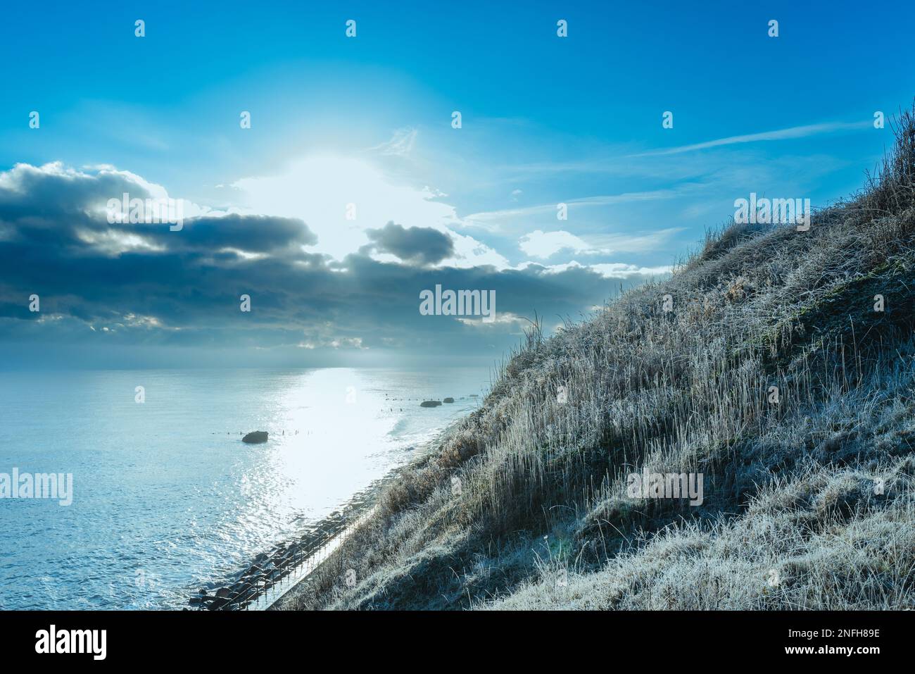 Cold, early morning view of a sloping cliff covered with frost. A ...