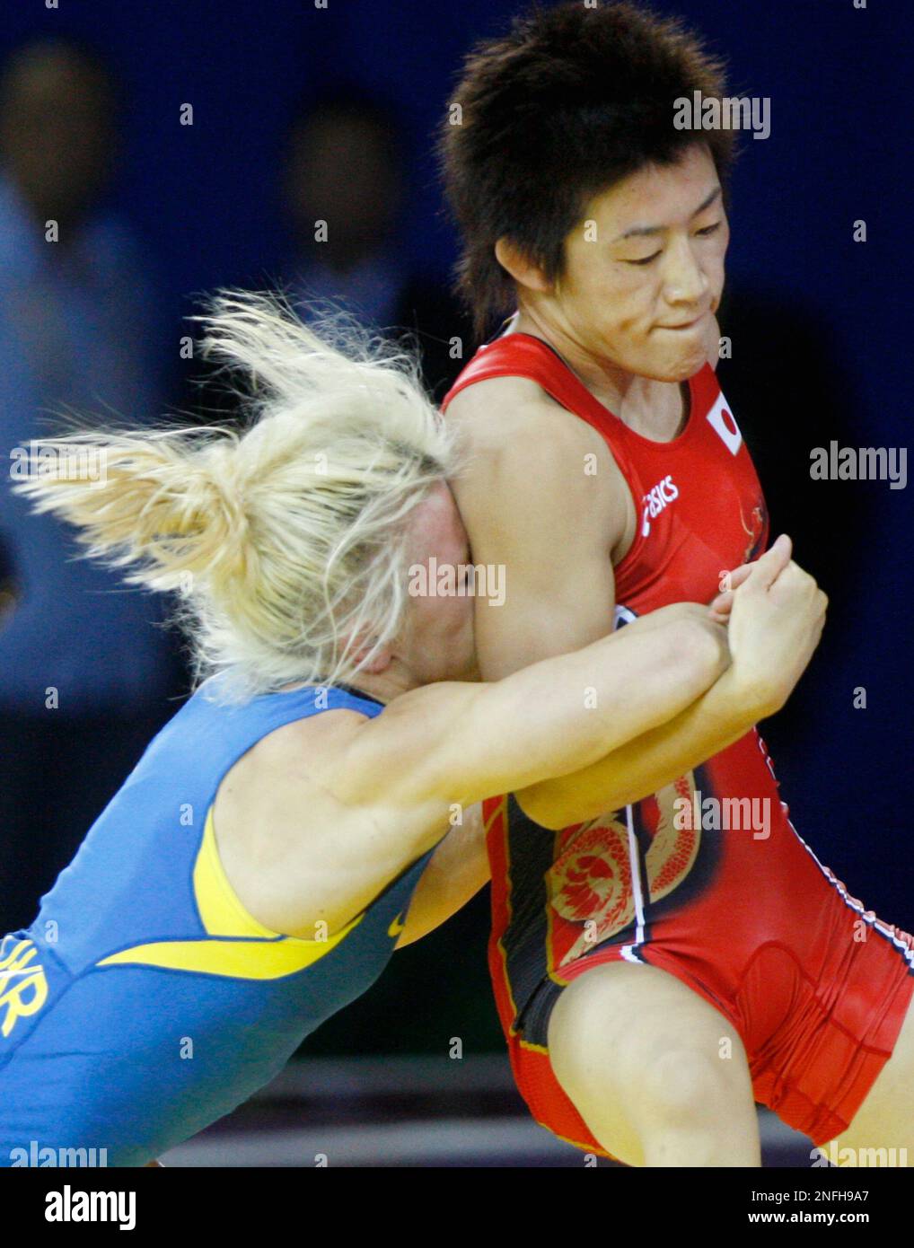 Japan's Chiharu Icho, in red, wrestles Ukraine's Irini Merlini during ...