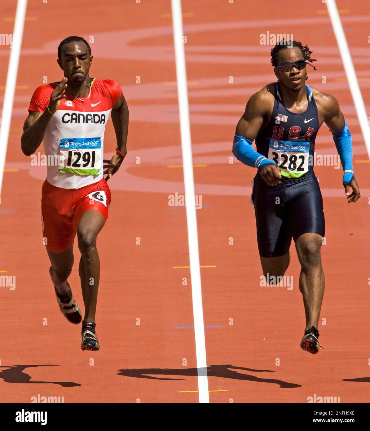 Canada's Anson Henry, left, from Pickering, Ont., runs with Walter Dix ...
