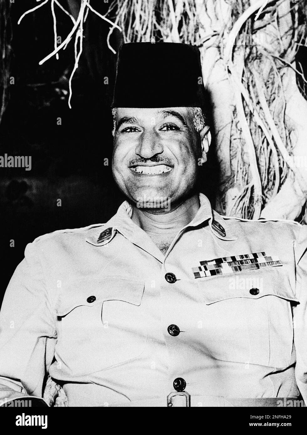 Egyptian leader Col. Gamal Abdel Nasser smiles as he tries on a fez ...