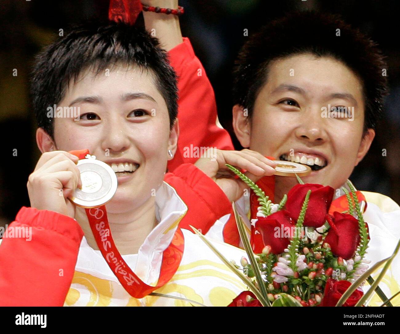 China's Yu Yang, left, and Du Jing, show their gold medals in the women ...