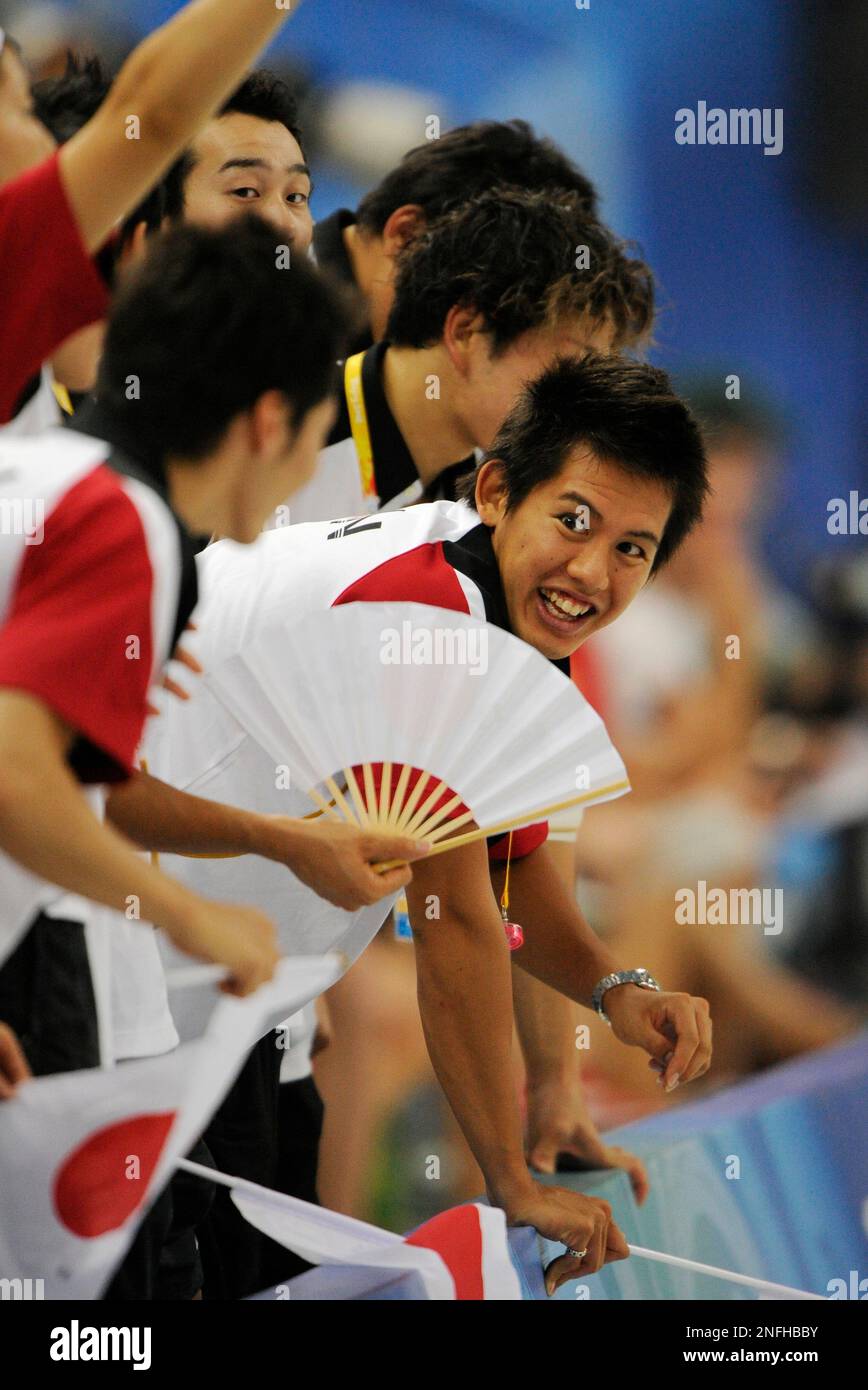 Members of the Japanese swim team cheer during the swimming ...