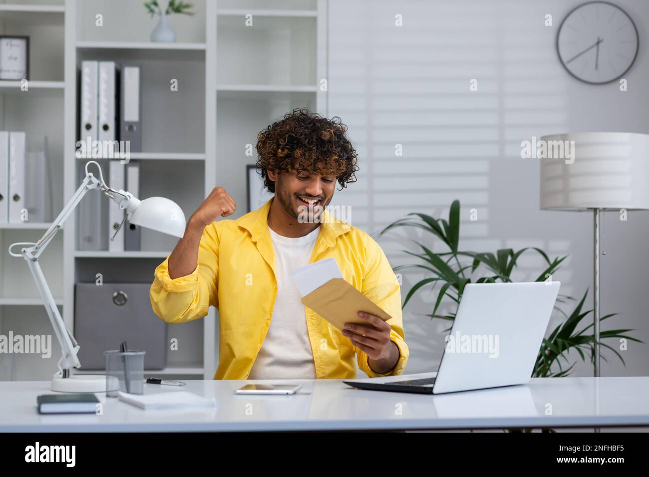 Successful hispanic businessman inside home office, man in yellow shirt ...