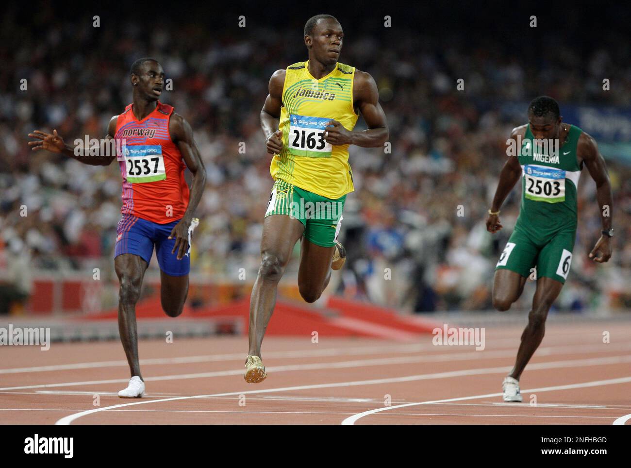 Jamaica's Usain Bolt, center, crosses the finsh line with Norway's ...