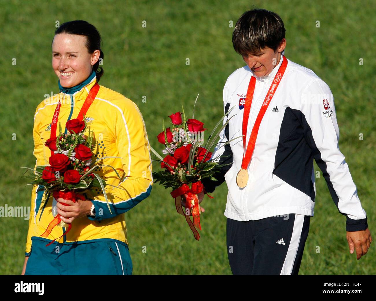 Australia's Jacqueline Lawrence with her silver medal, left, walks with ...