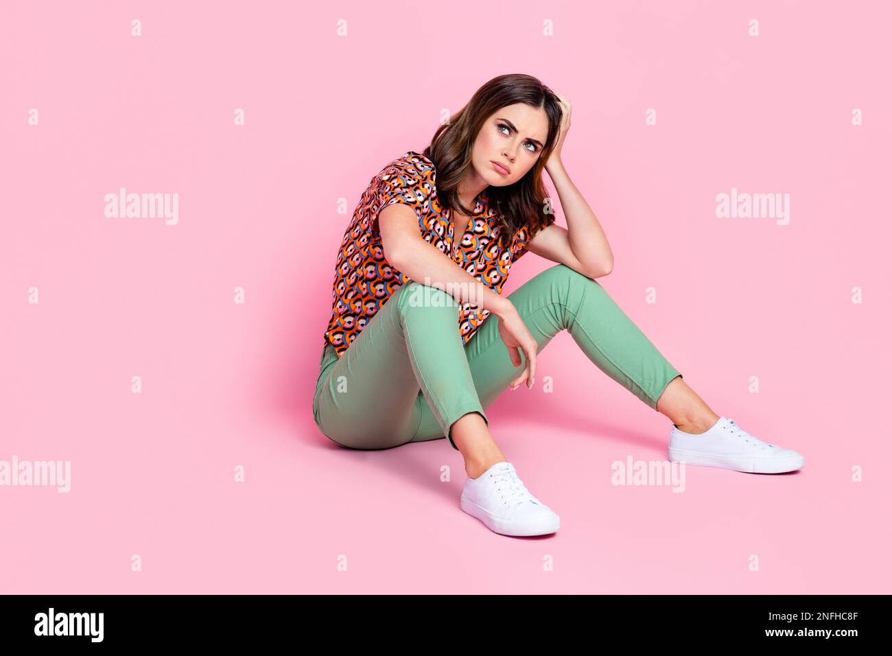 Full body photo of unsatisfied moody lady sit floor arm touch head look ...