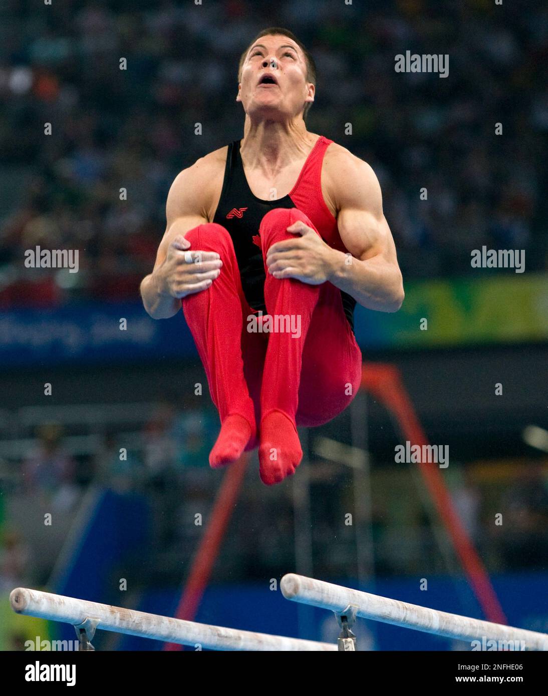 Canada's Adam Wong, from Calgary, performs on the parallel bars during ...