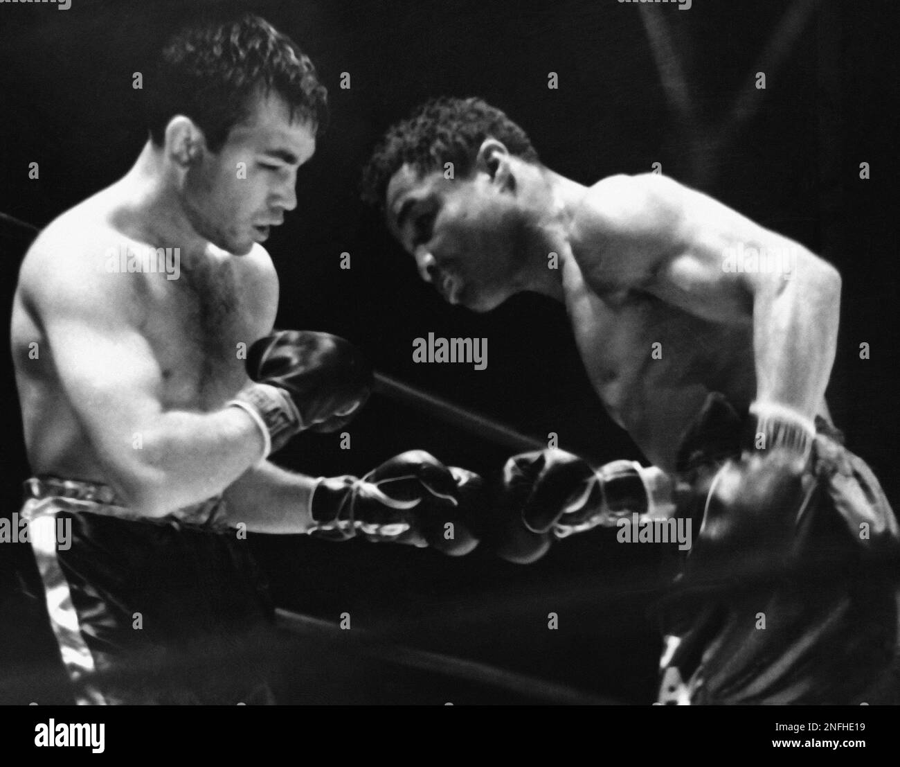 Henry Armstrong, right, bores in as Barney Ross retreat from a corner ...