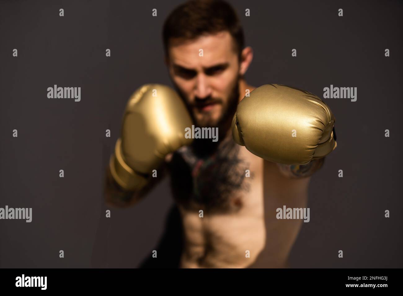 a man trains in boxing gloves on the street Stock Photo - Alamy