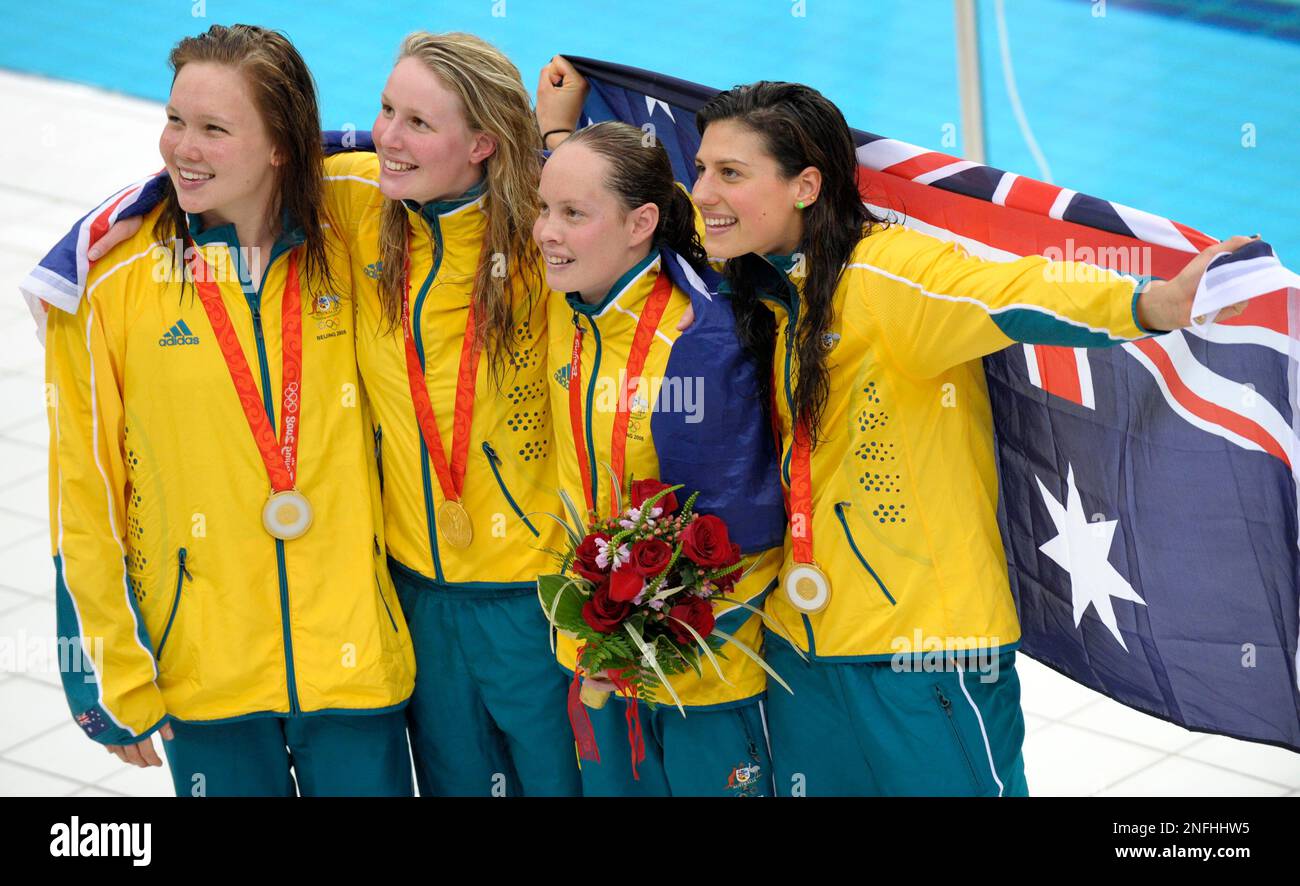 Australian women's 4x200-meter freestyle relay team members celebrate with their gold medals ...