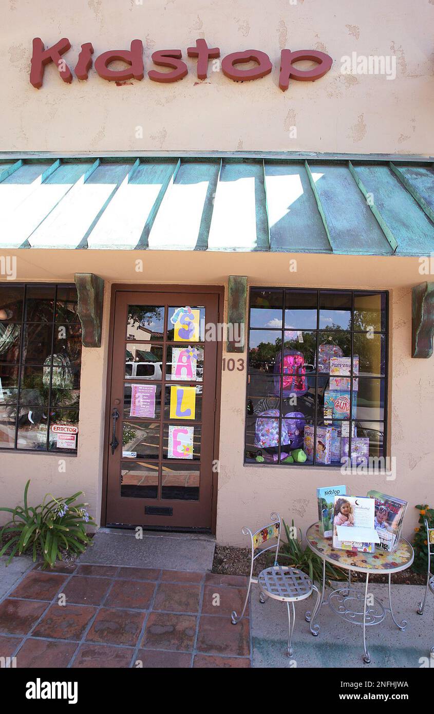 The storefront with "sale" sign in the front door at Kidstop ...