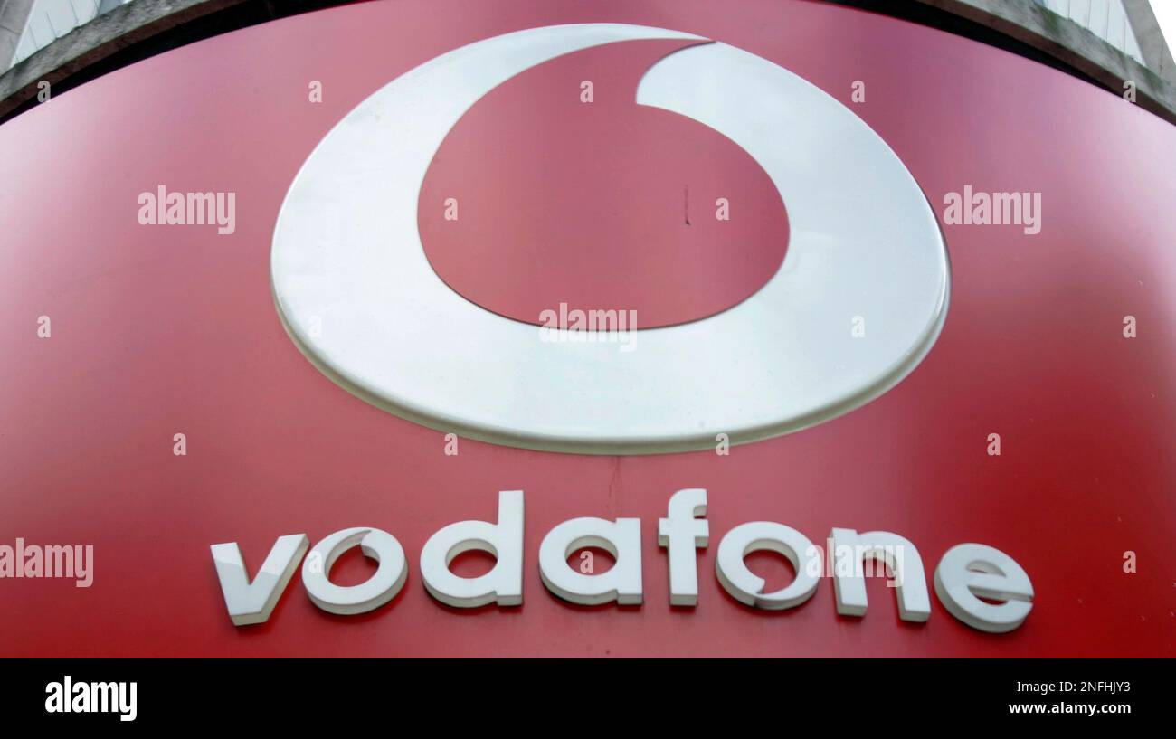 The logo for the Vodafone brand on one of its retail stores in Oxford ...