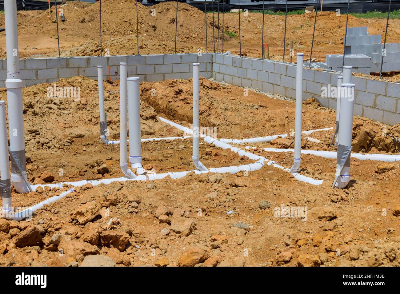Installation of utility pipes water pipes under foundation of new home ...