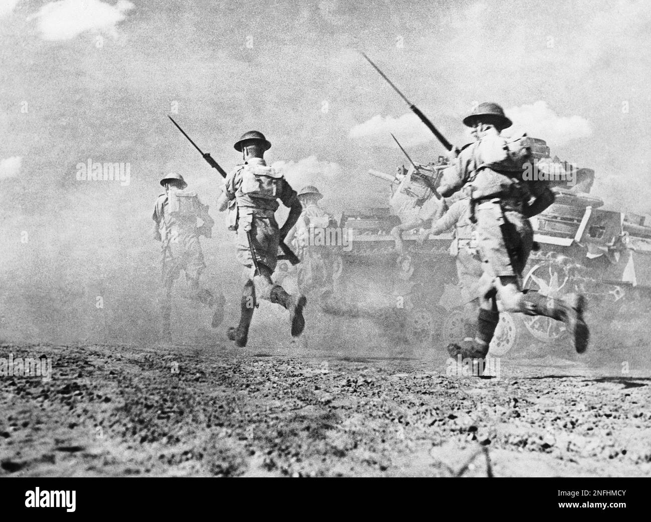 British Eighth Army infantrymen run through the dust of the Western ...