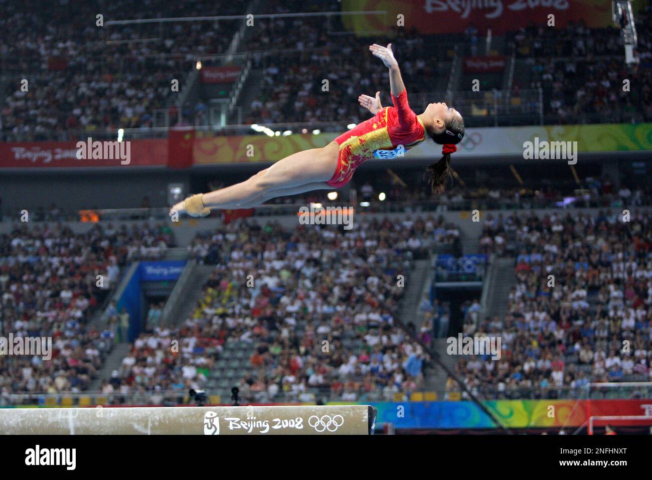 China's Li Shanshan competes on the balance beam during the gymnastics ...