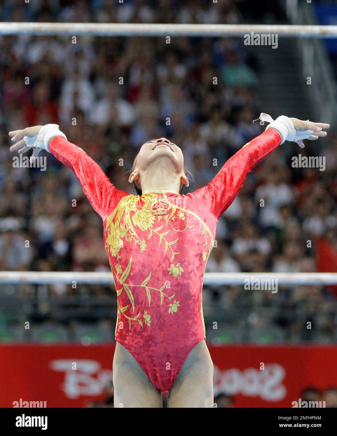 China's gymnast Yang Yilin poses after finishing her uneven bars ...
