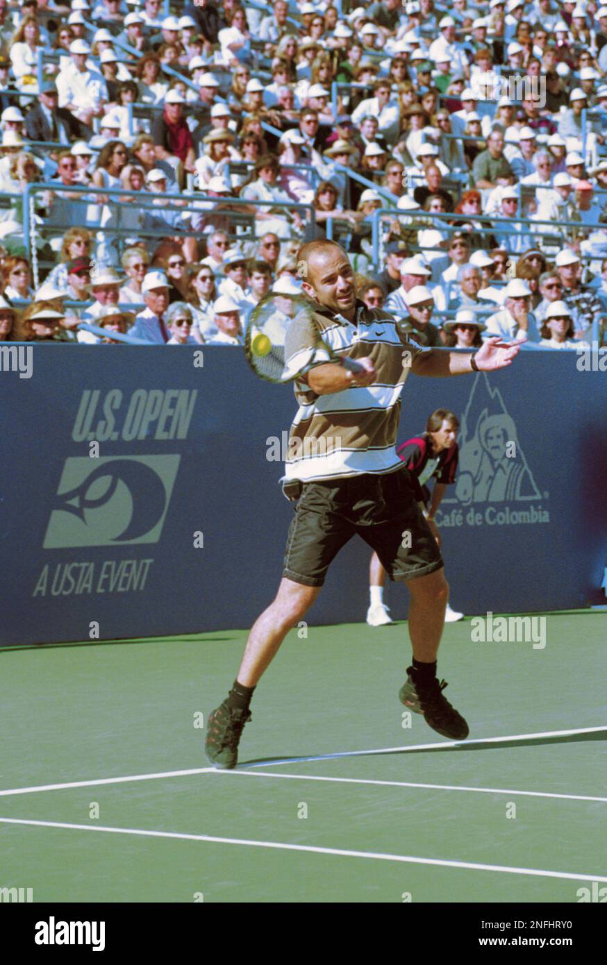 Andre Agassi of Las Vegas returns the ball to Pete Sampras of Tampa ...