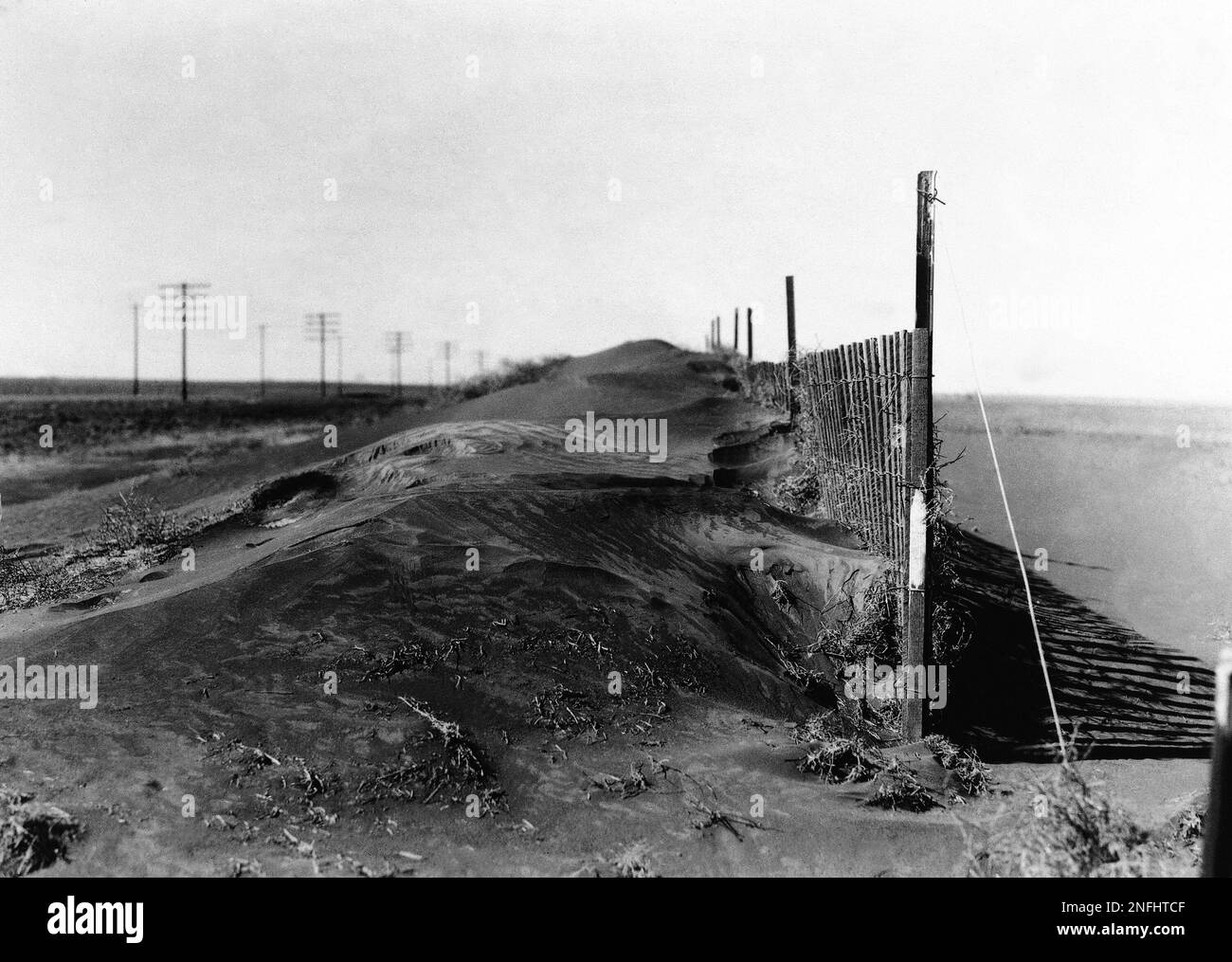 This picture shows a barrier erected to keep back snowdrifts nearly ...