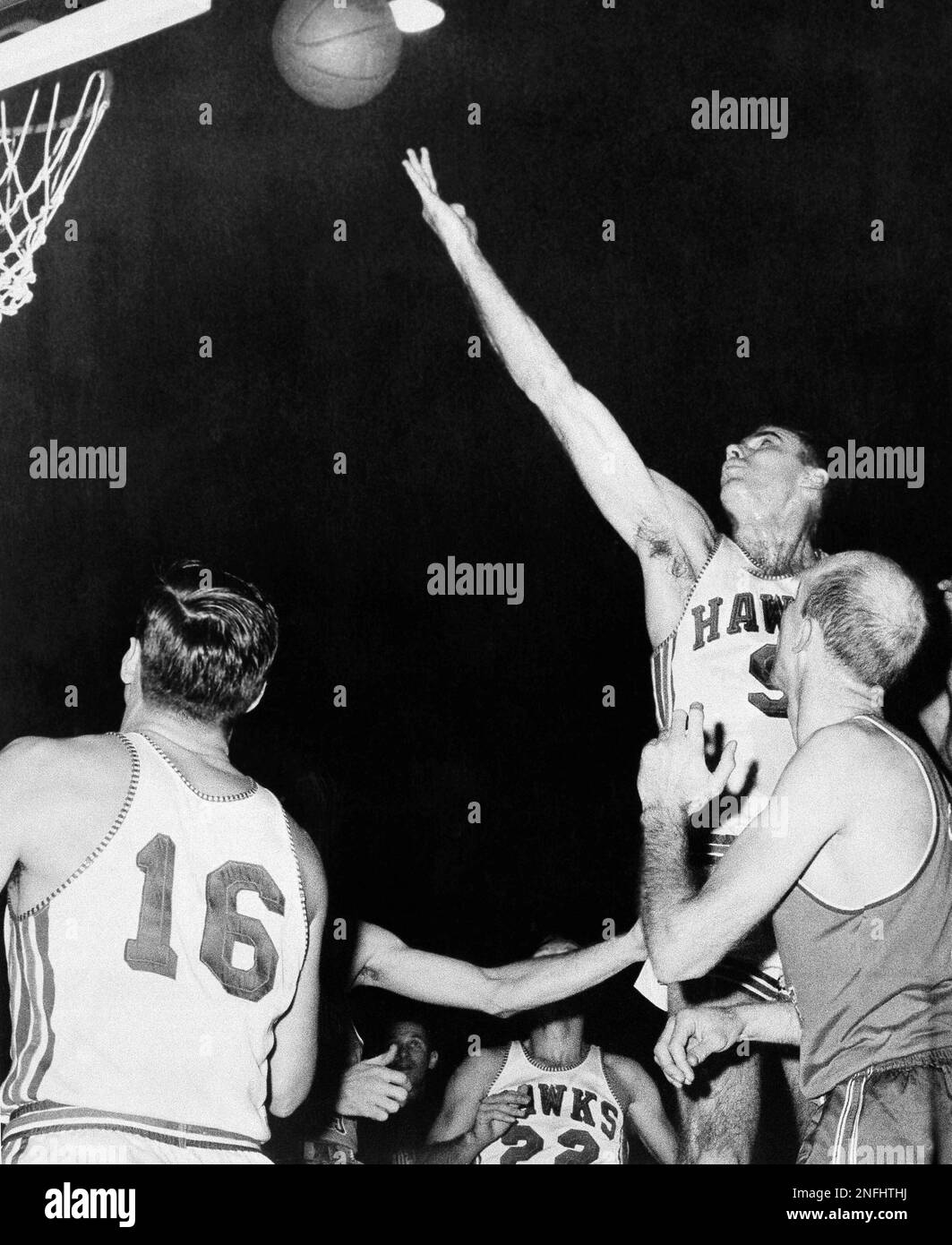Bob Pettit (9) of the St. Louis Hawks, lets the ball roll off his ...