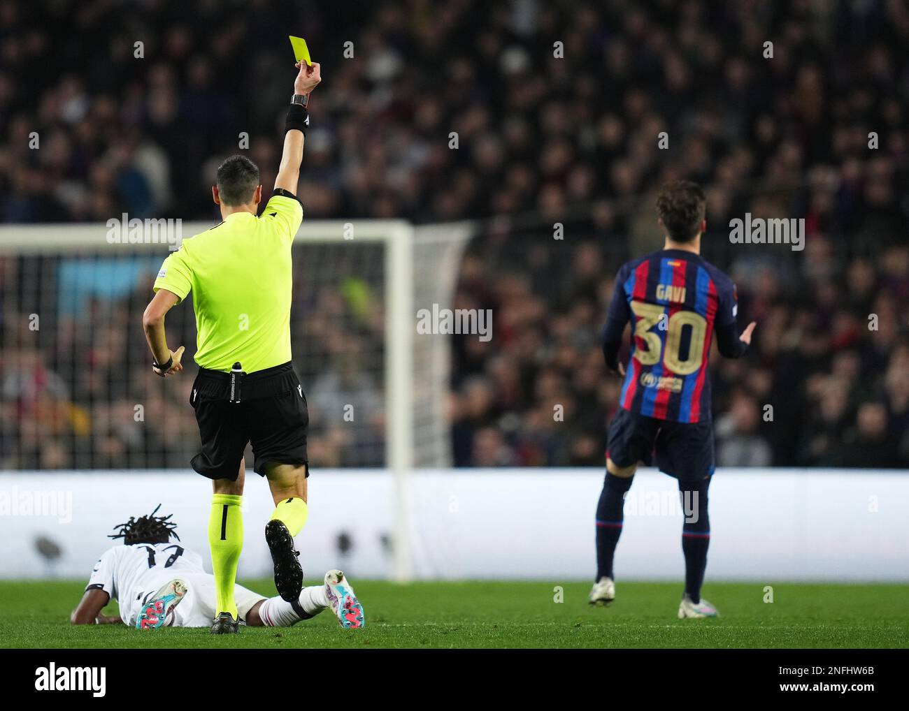 The referee Maurizio Mariani shows yellow card to Pablo Martin Gavira ...