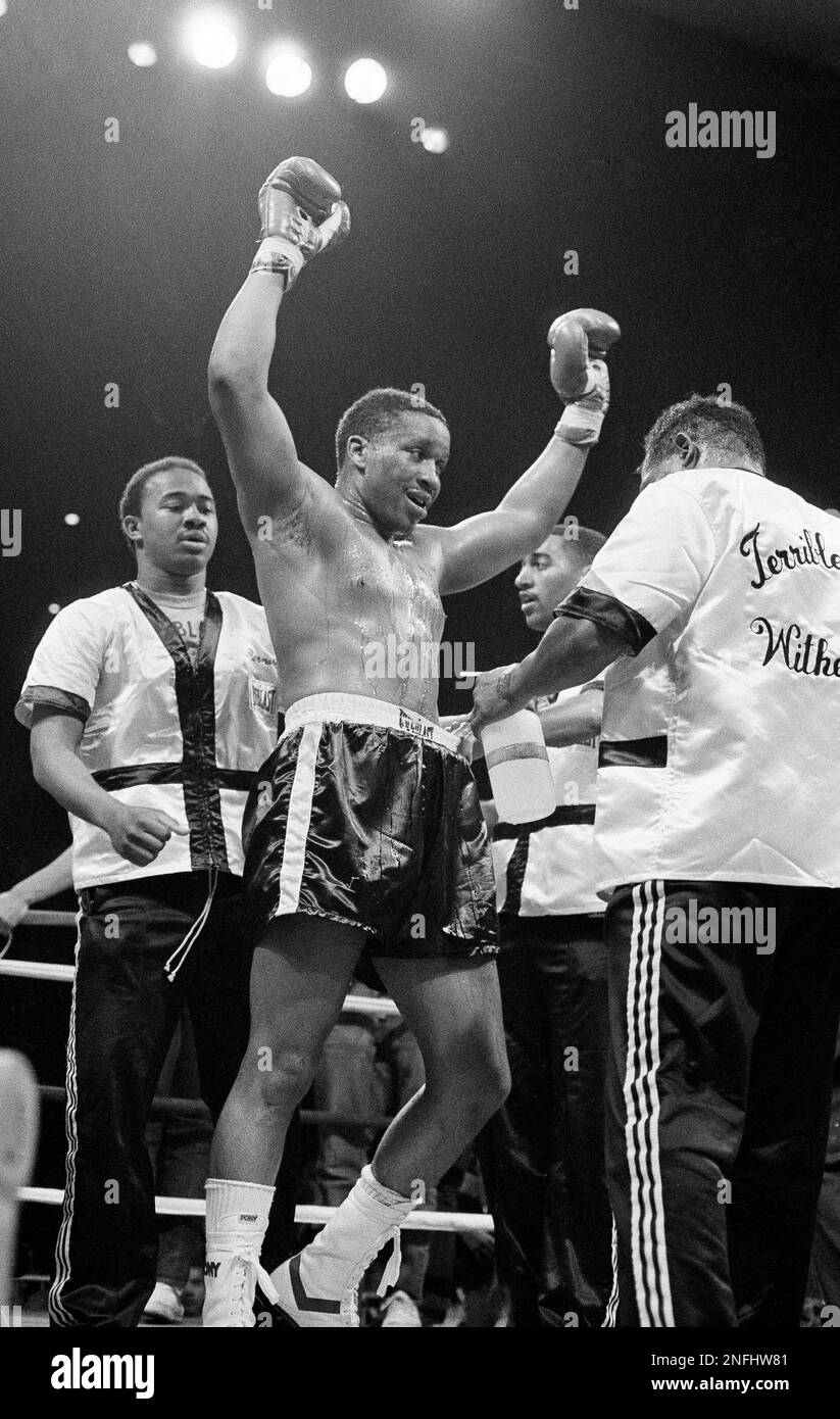 Tim Witherspoon raises his arms in victory after winning a 12-round ...