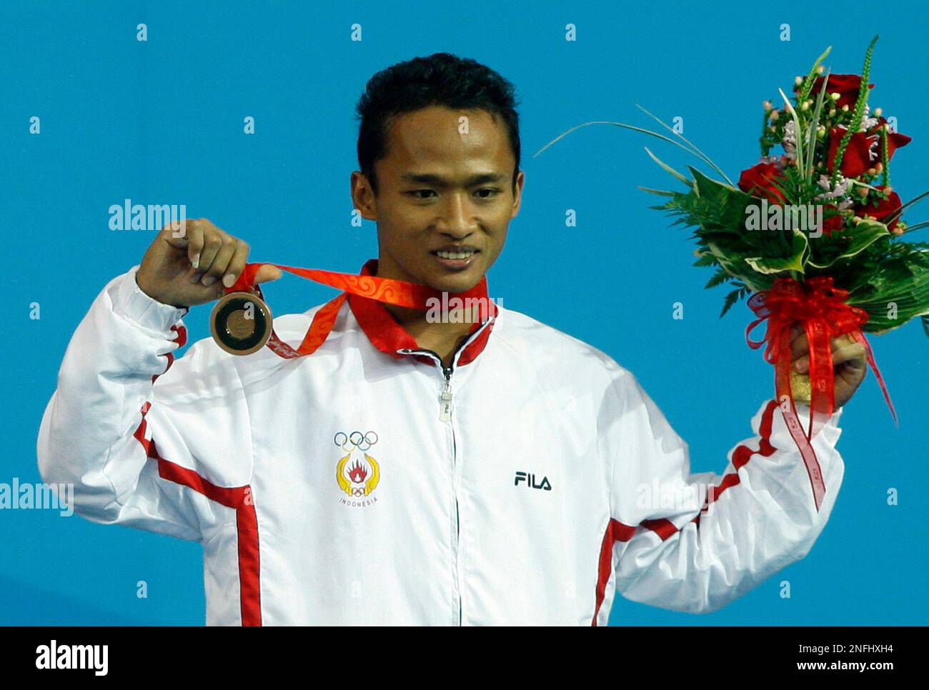 Indonesia's Triyanto,shows off his Bronze medal in the mens 62 kg ...