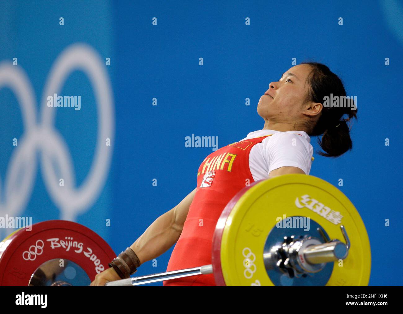 Chen Yanqing of China strains to lift 100 kilograms in her first ...