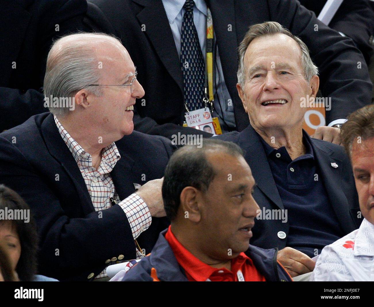 Former U.S. president George Bush, right, smiles as he watches the ...