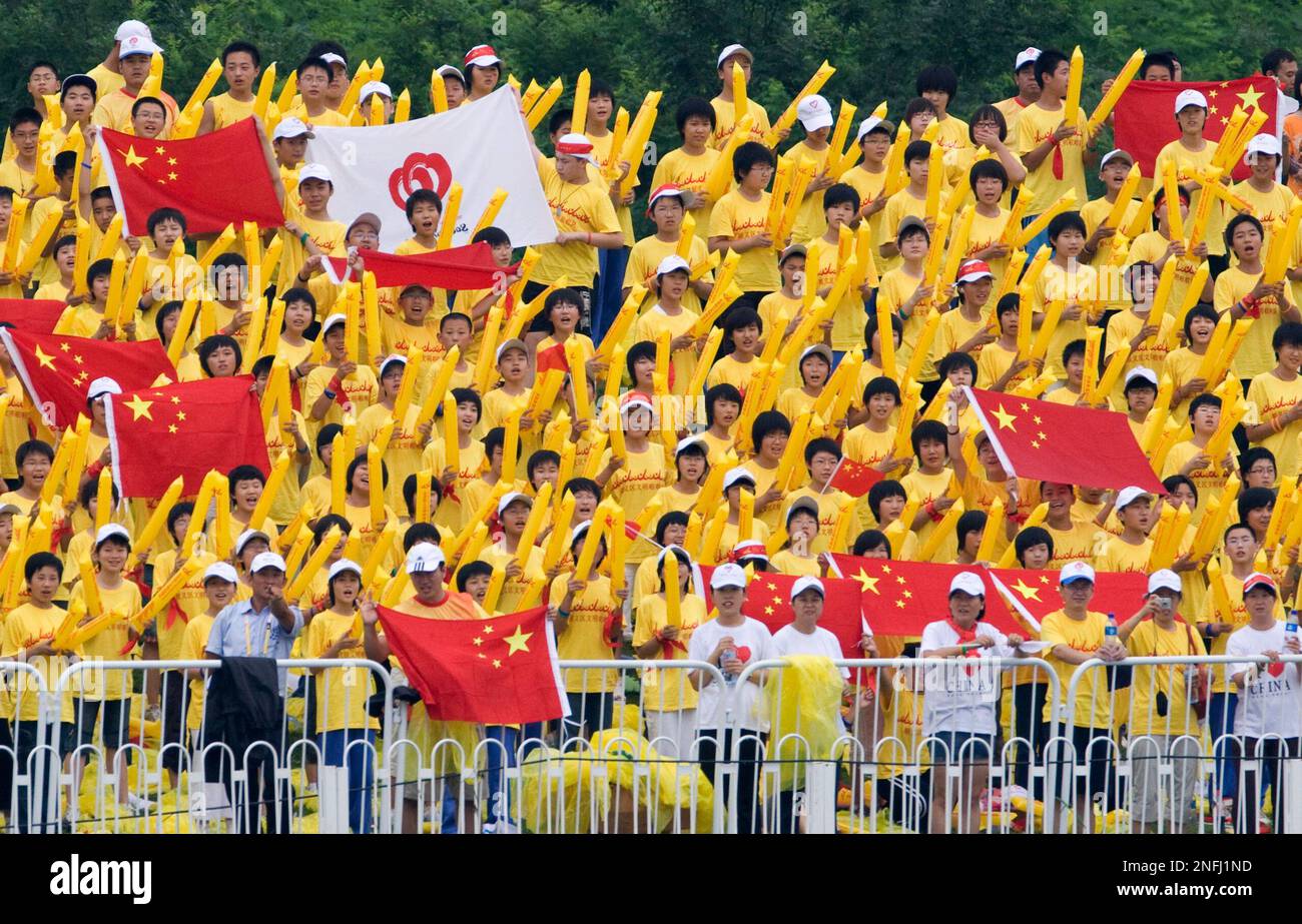 Chinese fans cheer on their men's eight rowing team during the 1st heat ...