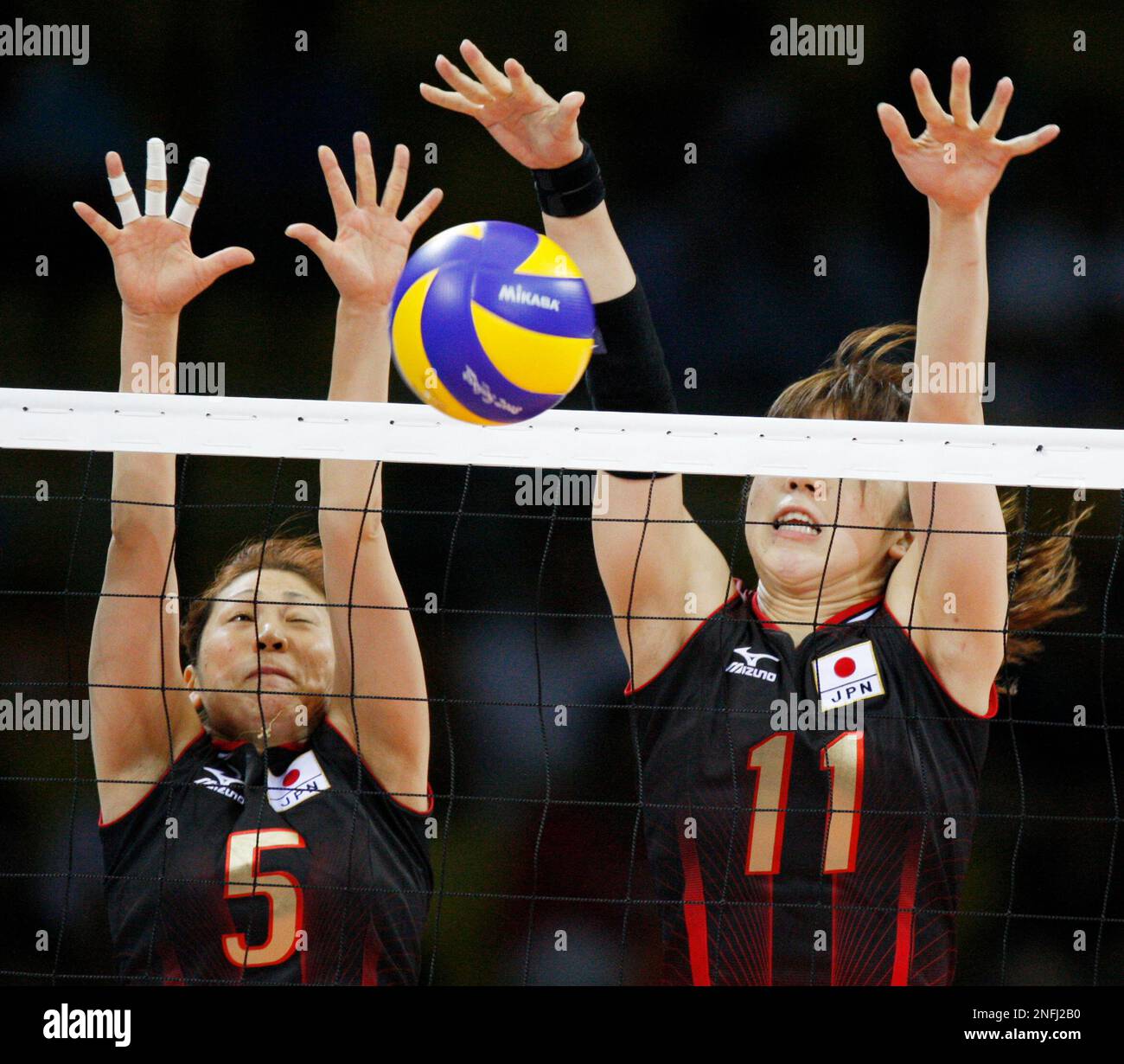 Japan's Miyuki Takahashi , left, and Erika Araki jump for the ball ...