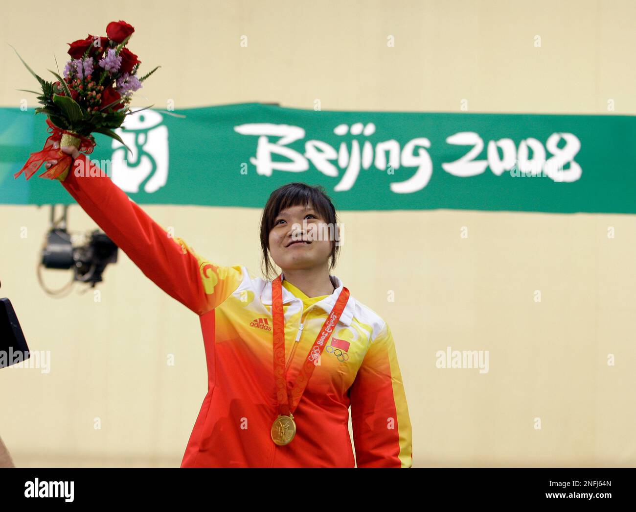 China's Guo Wenjun waves from the podium after winning the gold medal ...