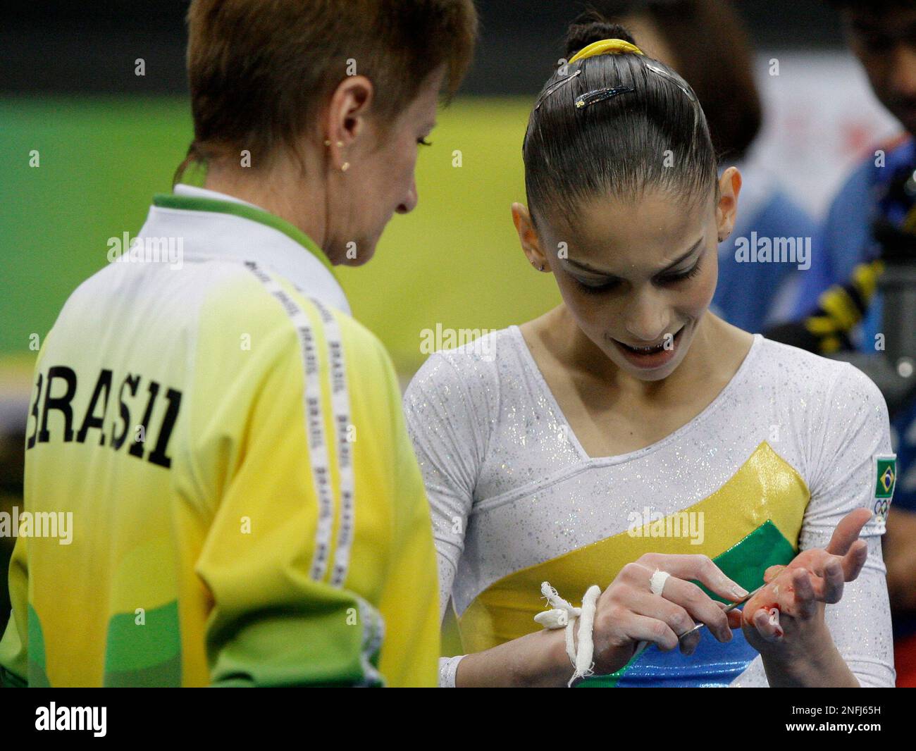 Brazil's gymnast Ana Silva looks at her injured palm after her uneven ...