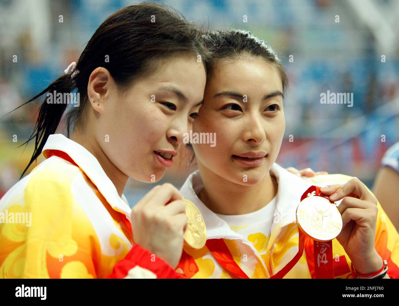 China's Jingjing Guo and Minxia Wu, right, show off their medals after ...