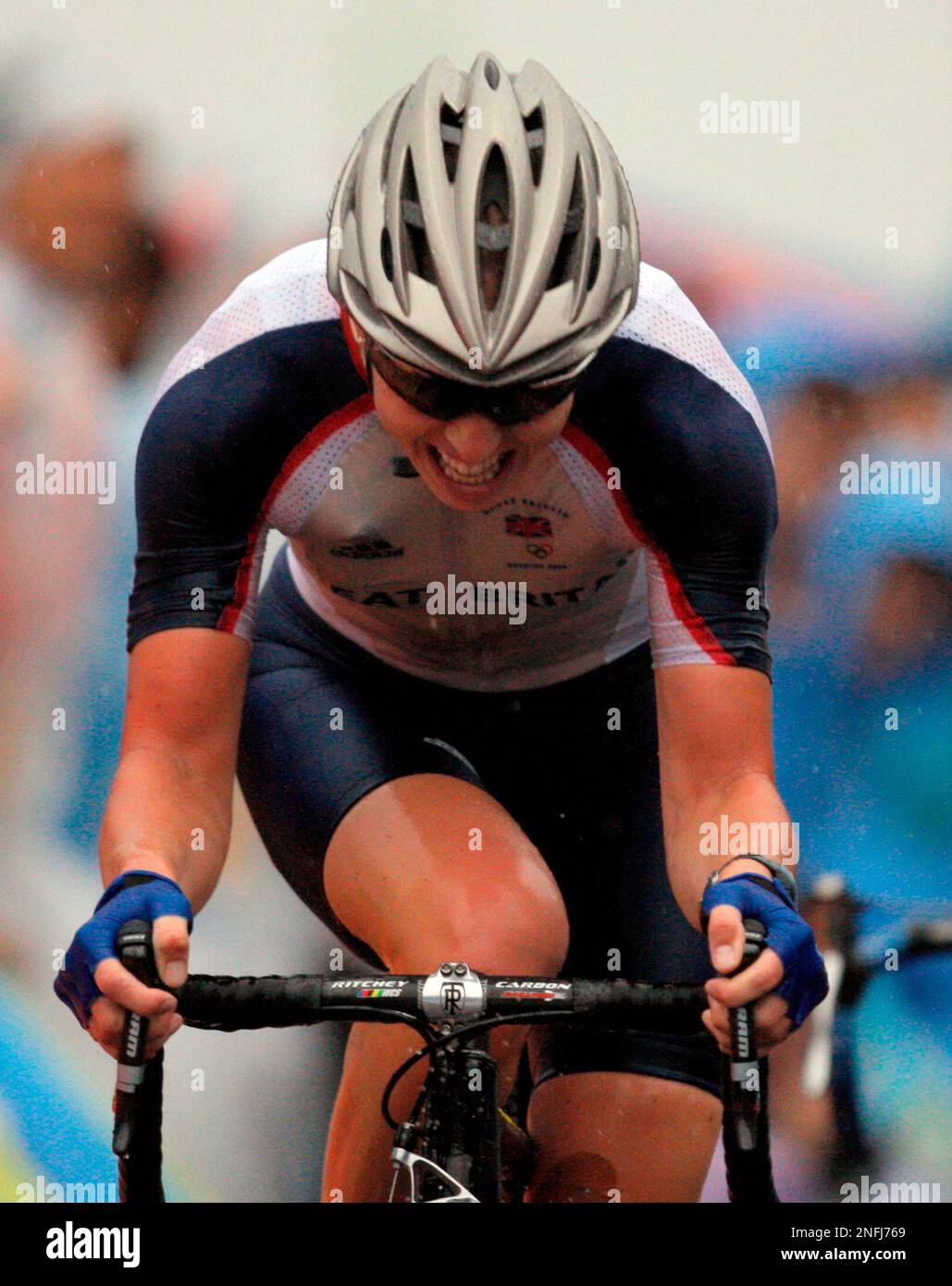 Britain's Nicole Cooke reacts as she crosses the finish line to win the ...