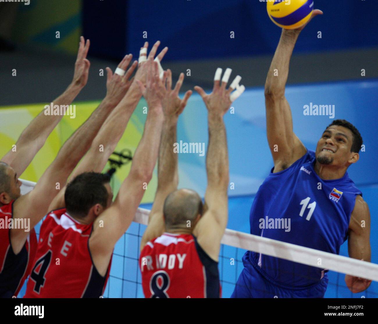 Venezuela's Ernardo Gomez (11) spikes the ball against USA's William ...