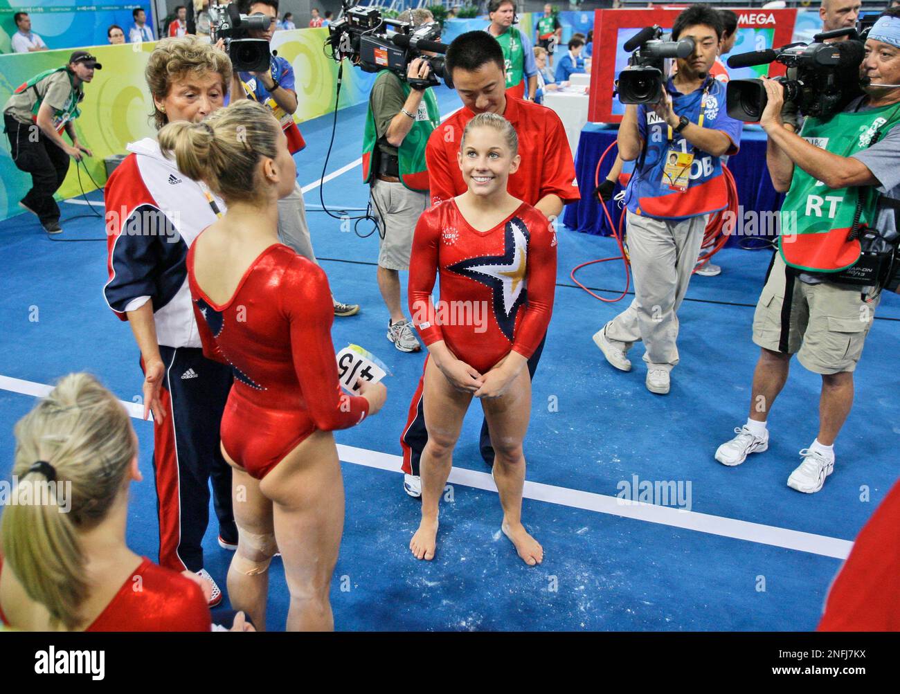 U.S. gymnast Shawn Johnson, center, is surrounded by team members ...