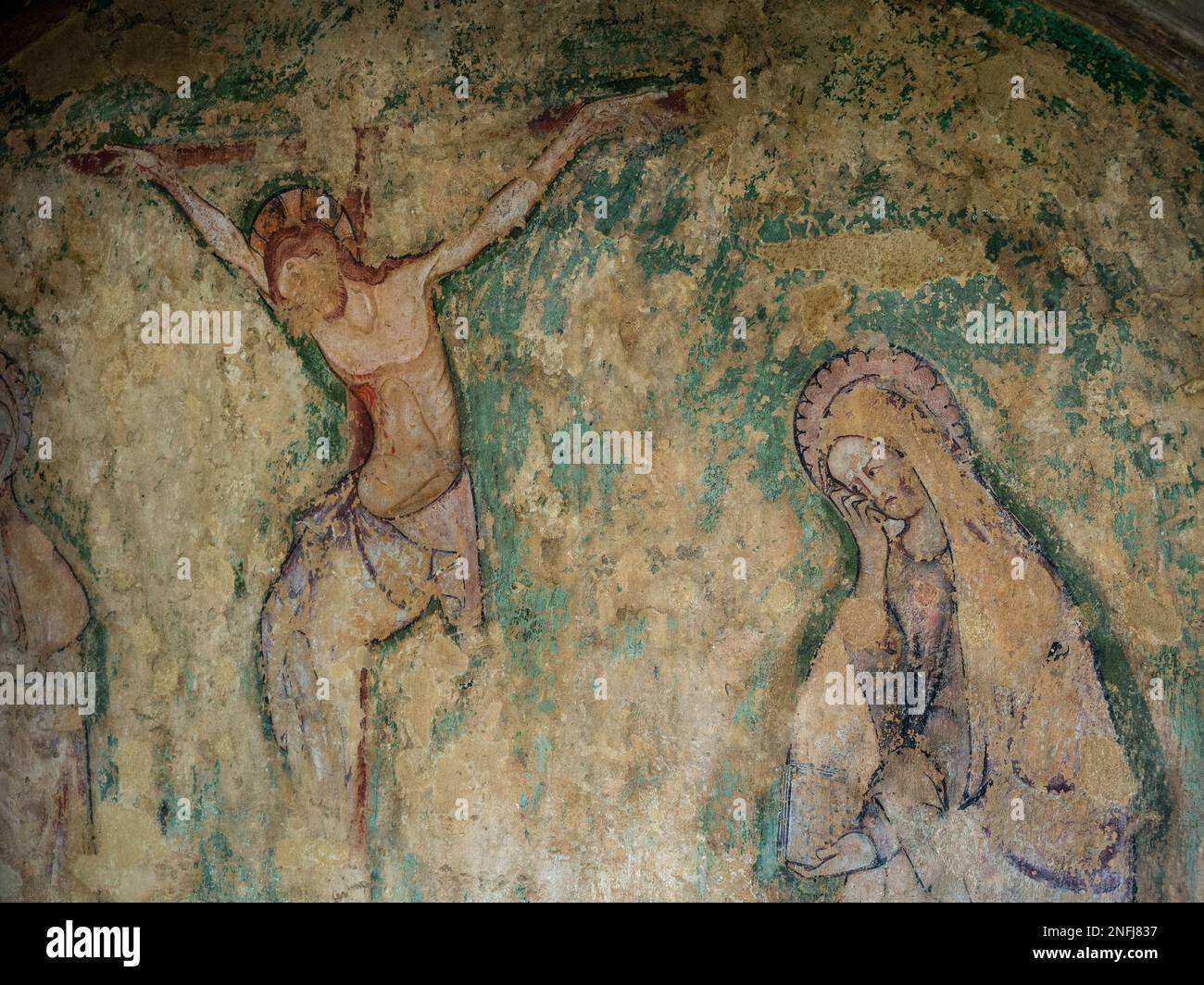 Close up of a 14th century wall painting of the crucifixion , All Saints church, Turvey ...