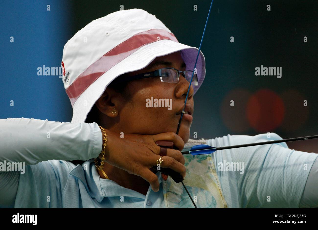 India's Dola Banerjee aims during the women's team archery competition ...