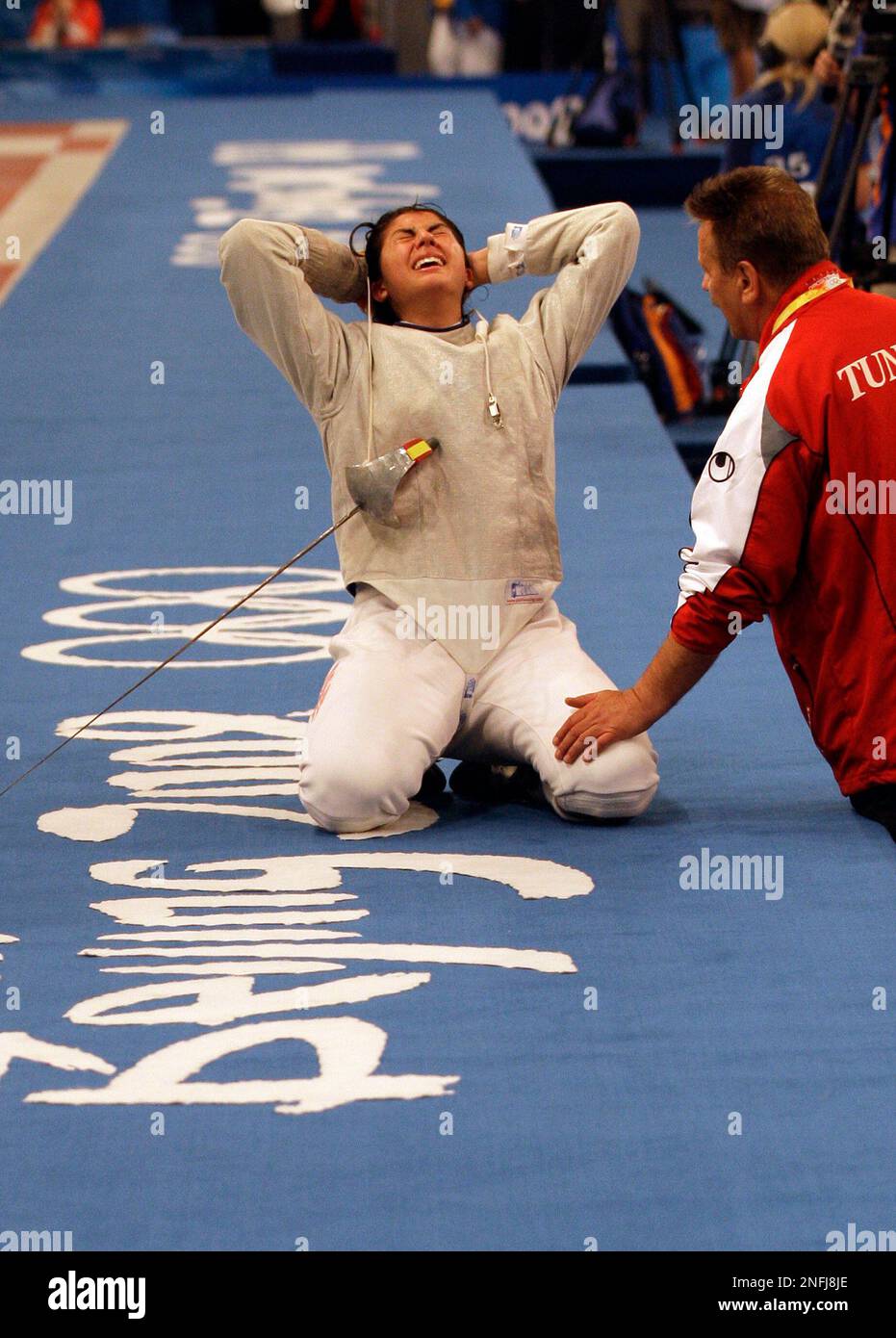 Azza Besbes of Tunisia cries on the floor following her quarterfinals ...