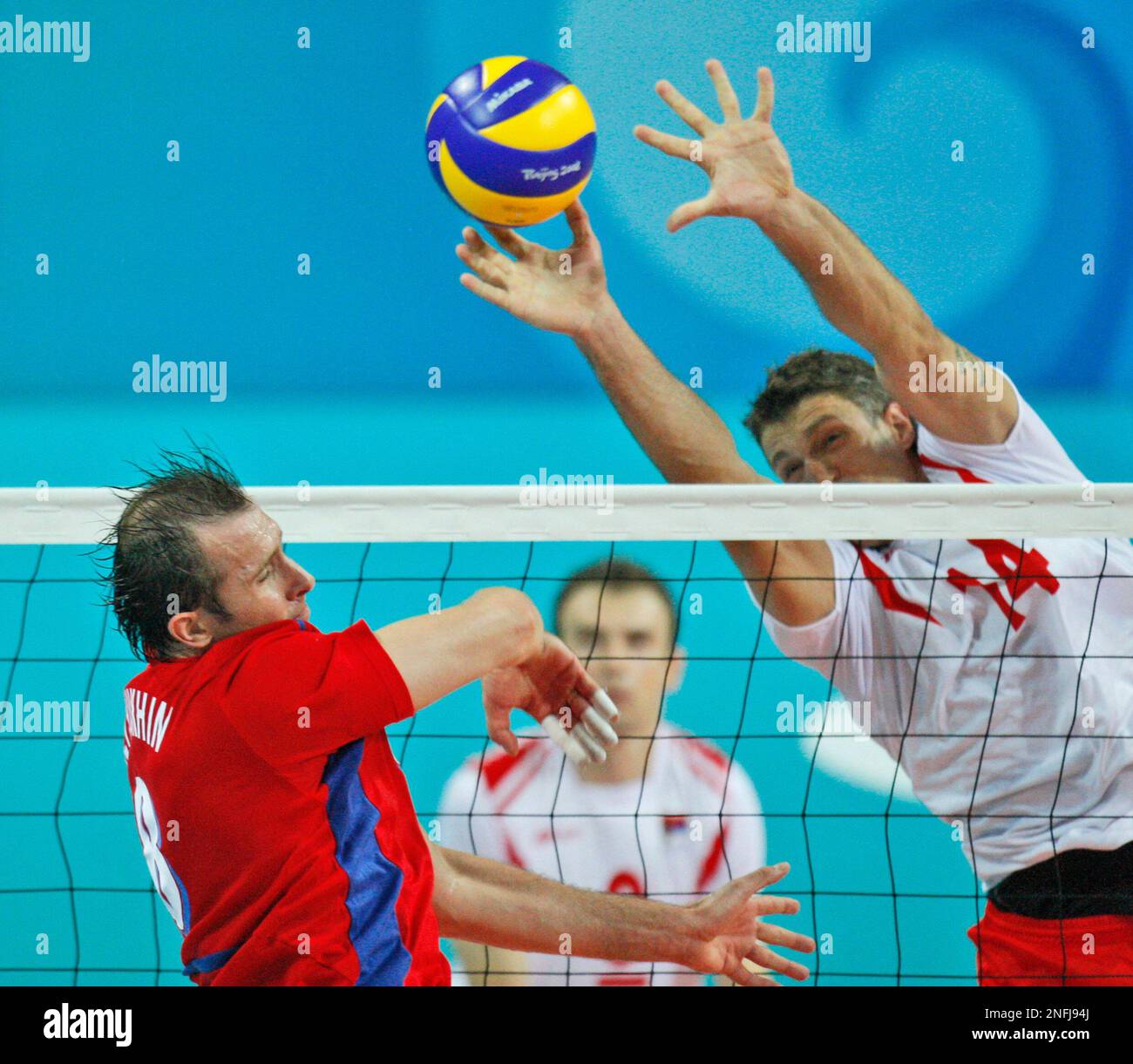 Russia's wing spiker Sergey Tetyukin, left, jumps with Serbia's ...