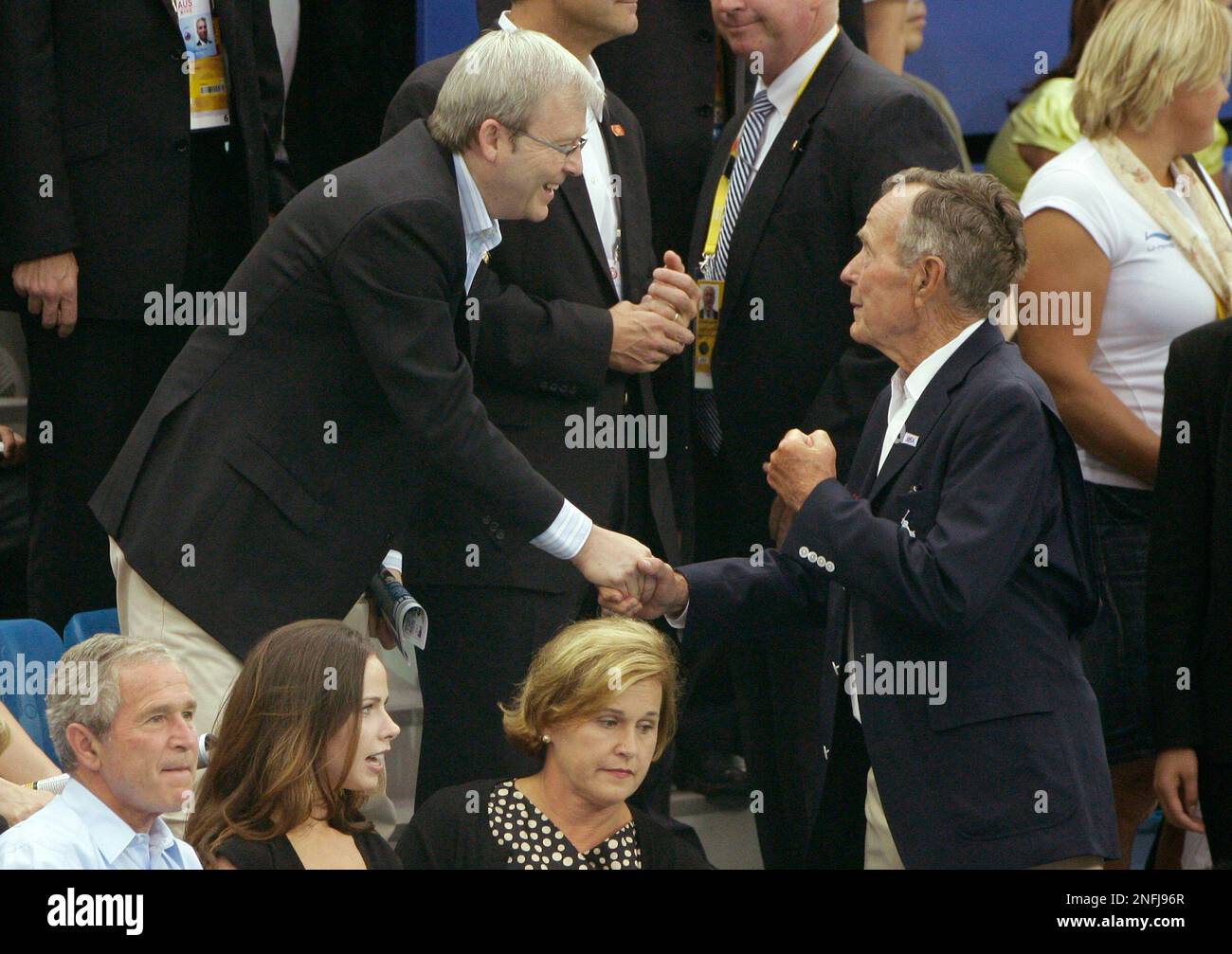Former U.S. President George H.W. Bush, right, shakes hands with ...