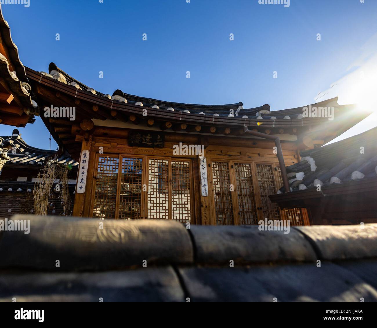 A low angle shot of a building under the blue sky in Jeonju Hanok ...
