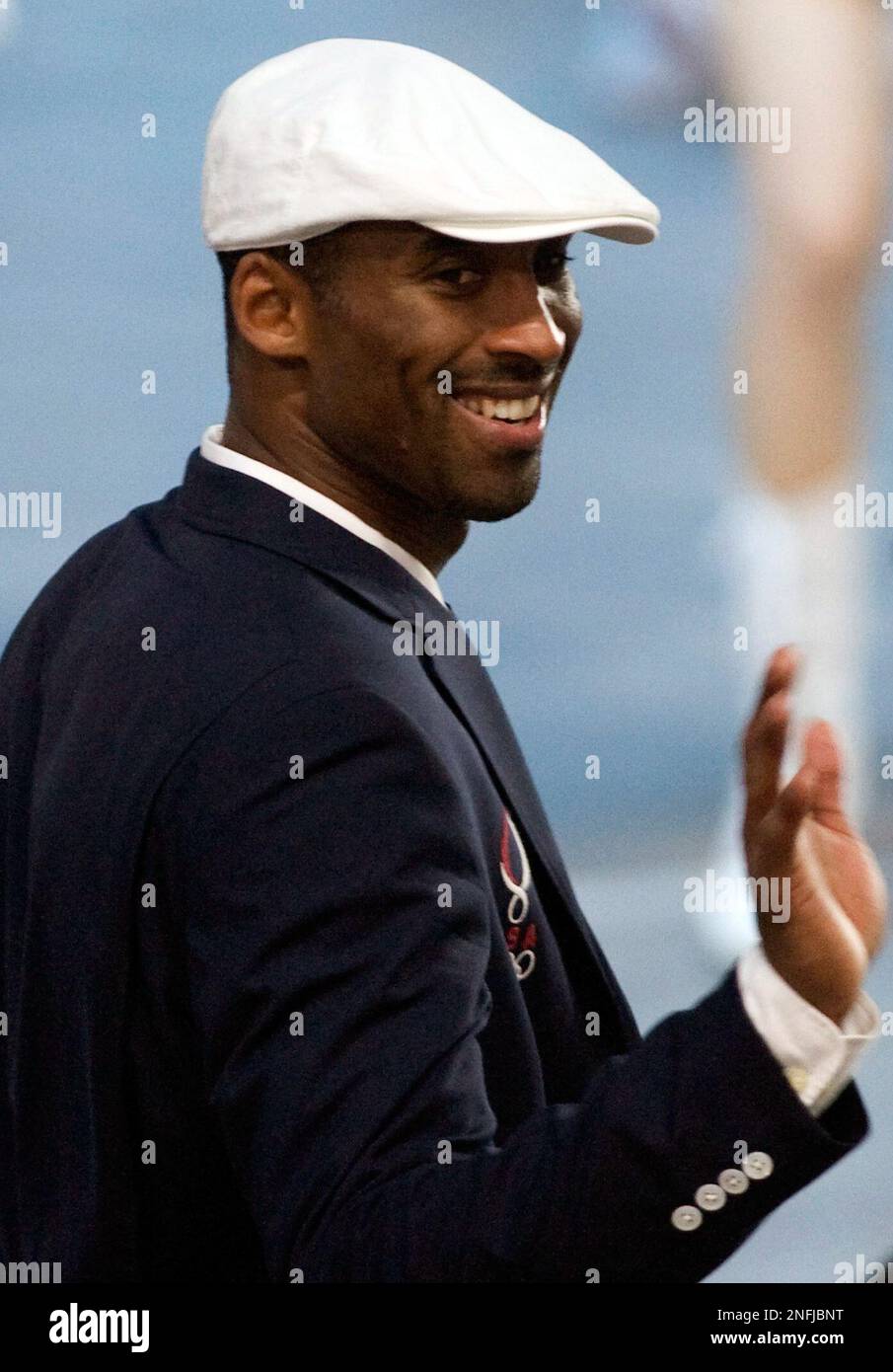 Team USA basketball player Kobe Bryant waves to a fan as he makes his ...