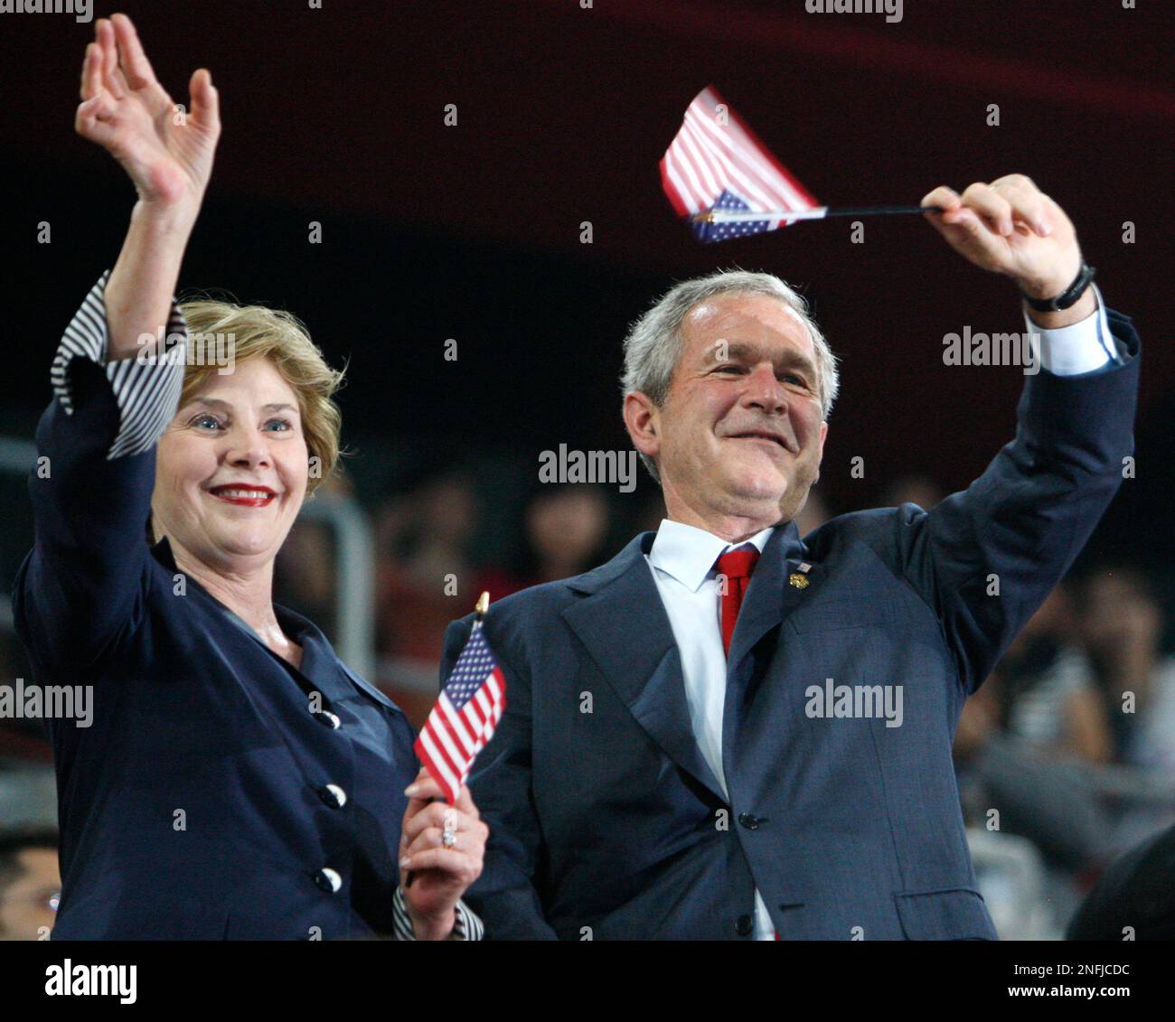 U.S. President George Bush and his wife Laura wave during the Beijing ...