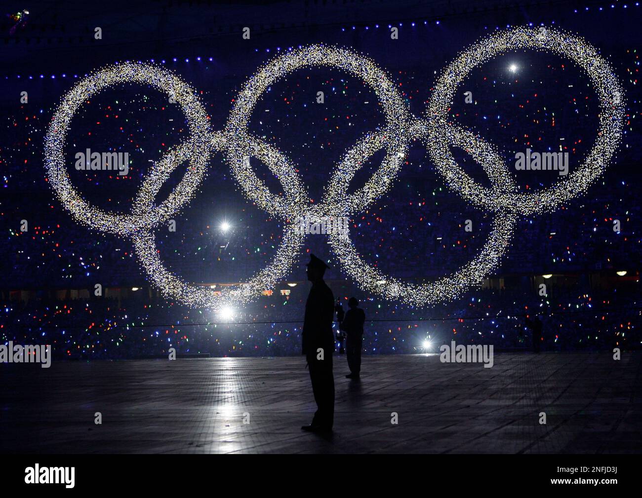 The five-ring Olympic symbol rises from the floor of the National ...