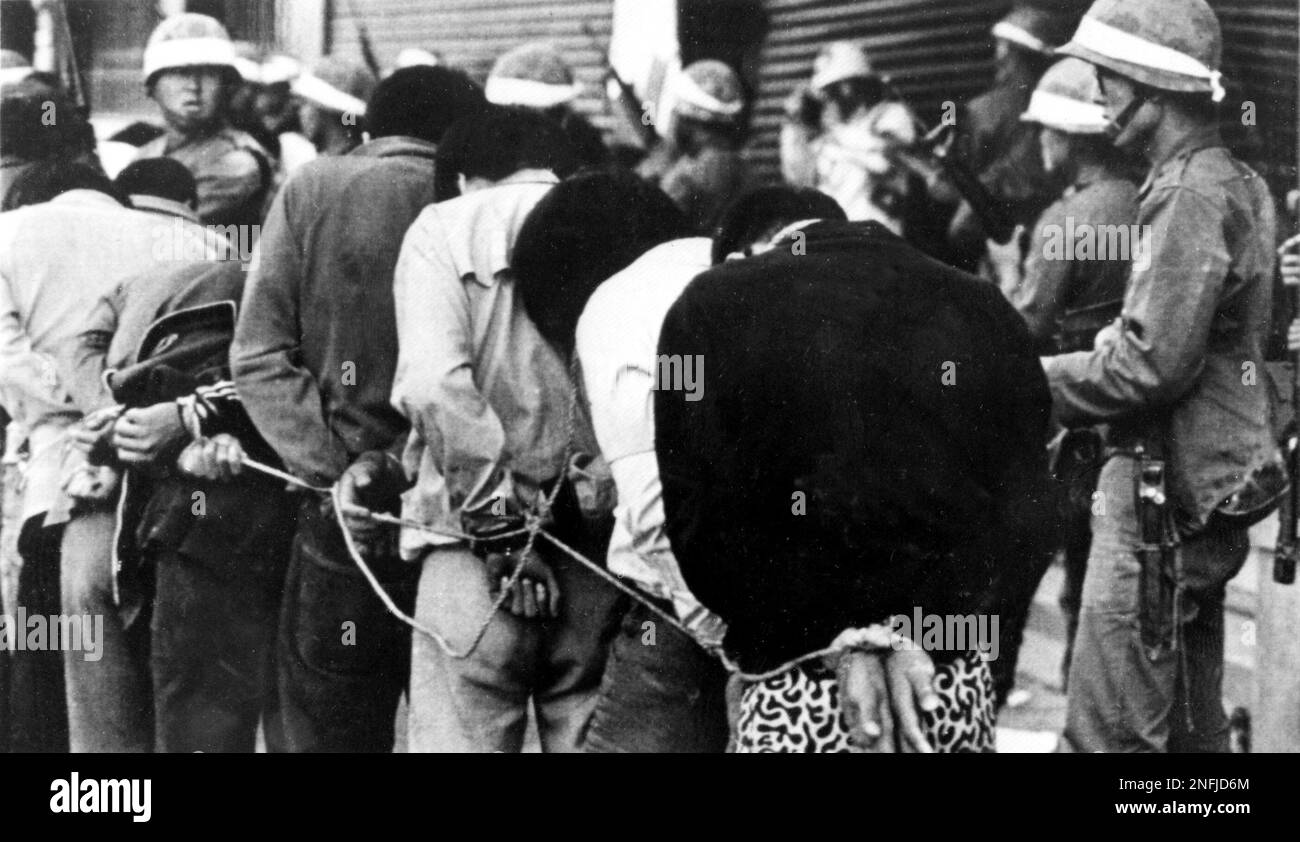 South Korean soldiers guard captured rebels who were rounded up Tuesday ...