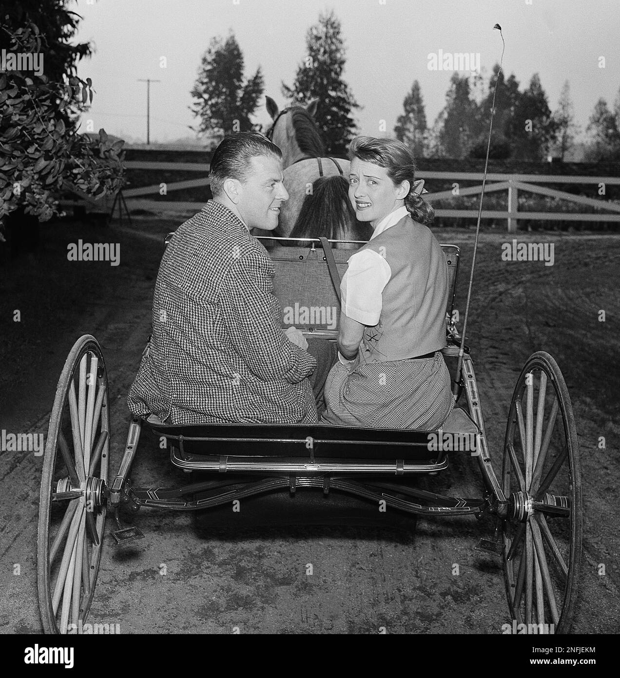 Bette Davis and her husband, Arthur Farnsworth, take a ride in a two ...