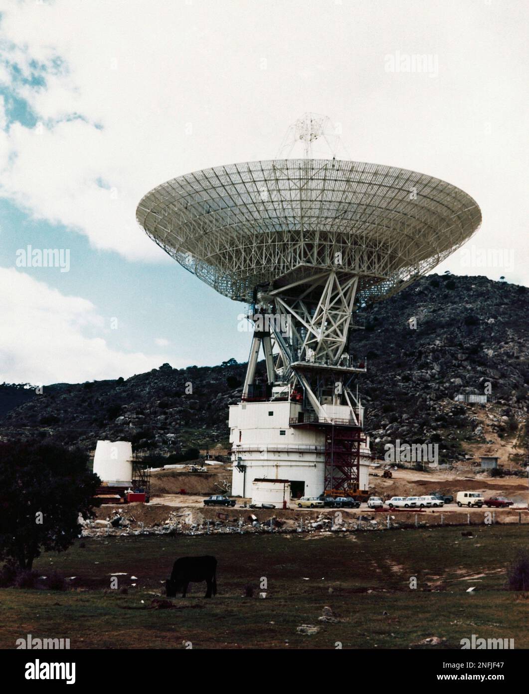 This giant tracking antenna, 64 meters (210 feet) in diameter, is ...