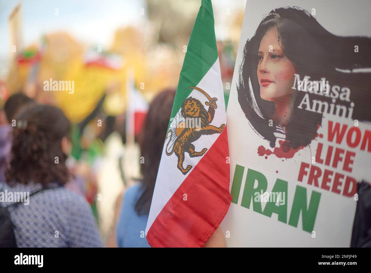 An Iranian flag and a protest sign at an Iranian protest in support of ...